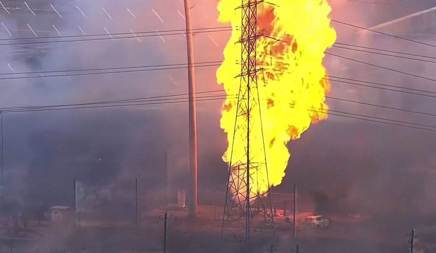 A pipeline explosion is shooting a towering pillar of flame over a ...